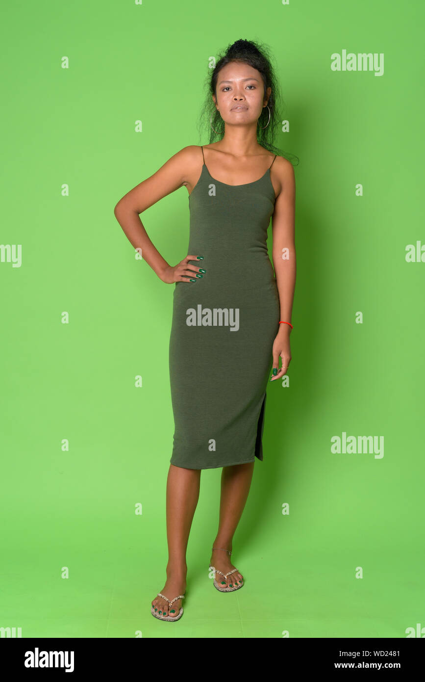Full body shot of young Asian woman with curly hair Stock Photo - Alamy