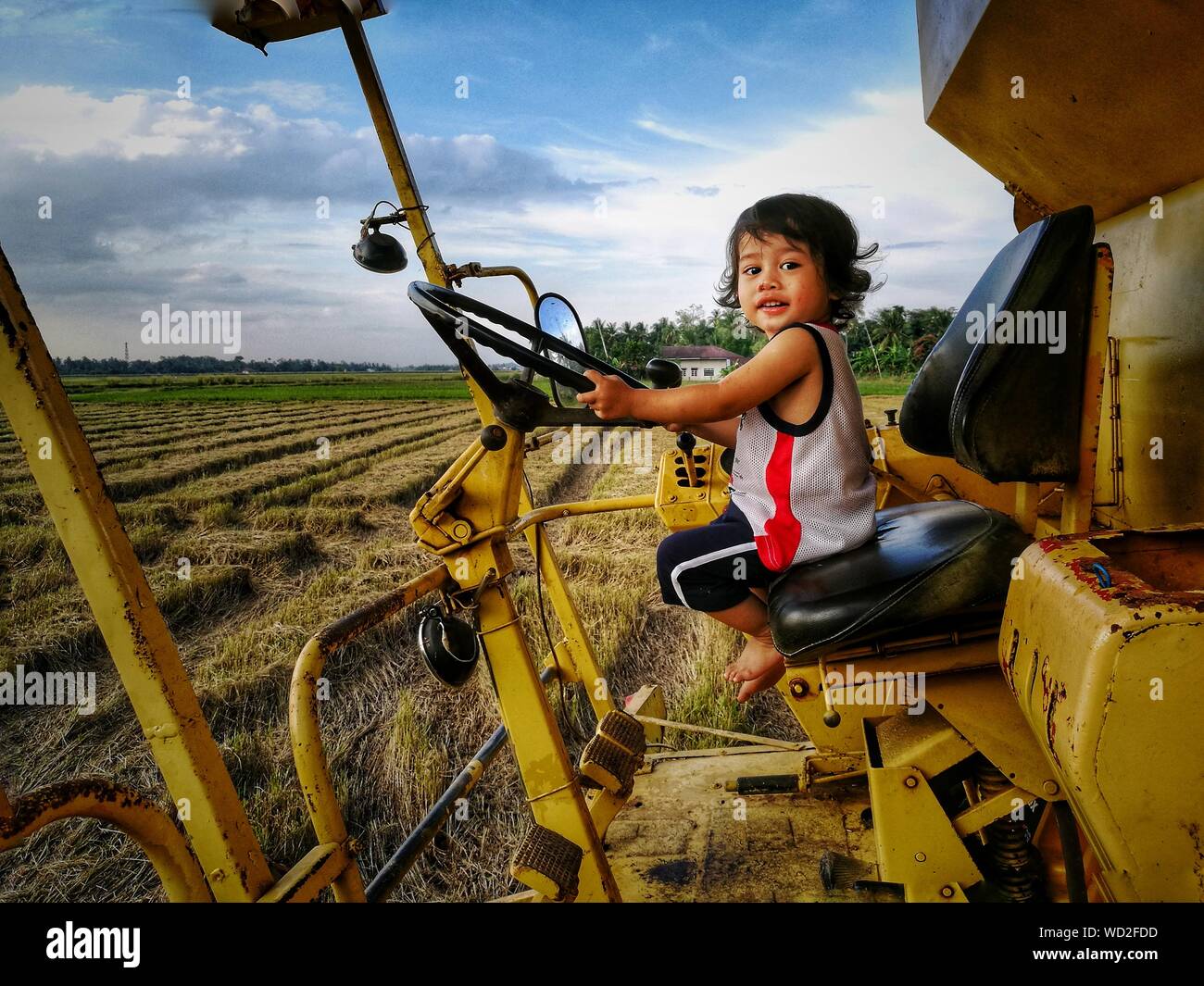 Boy on tractor hi-res stock photography and images - Alamy