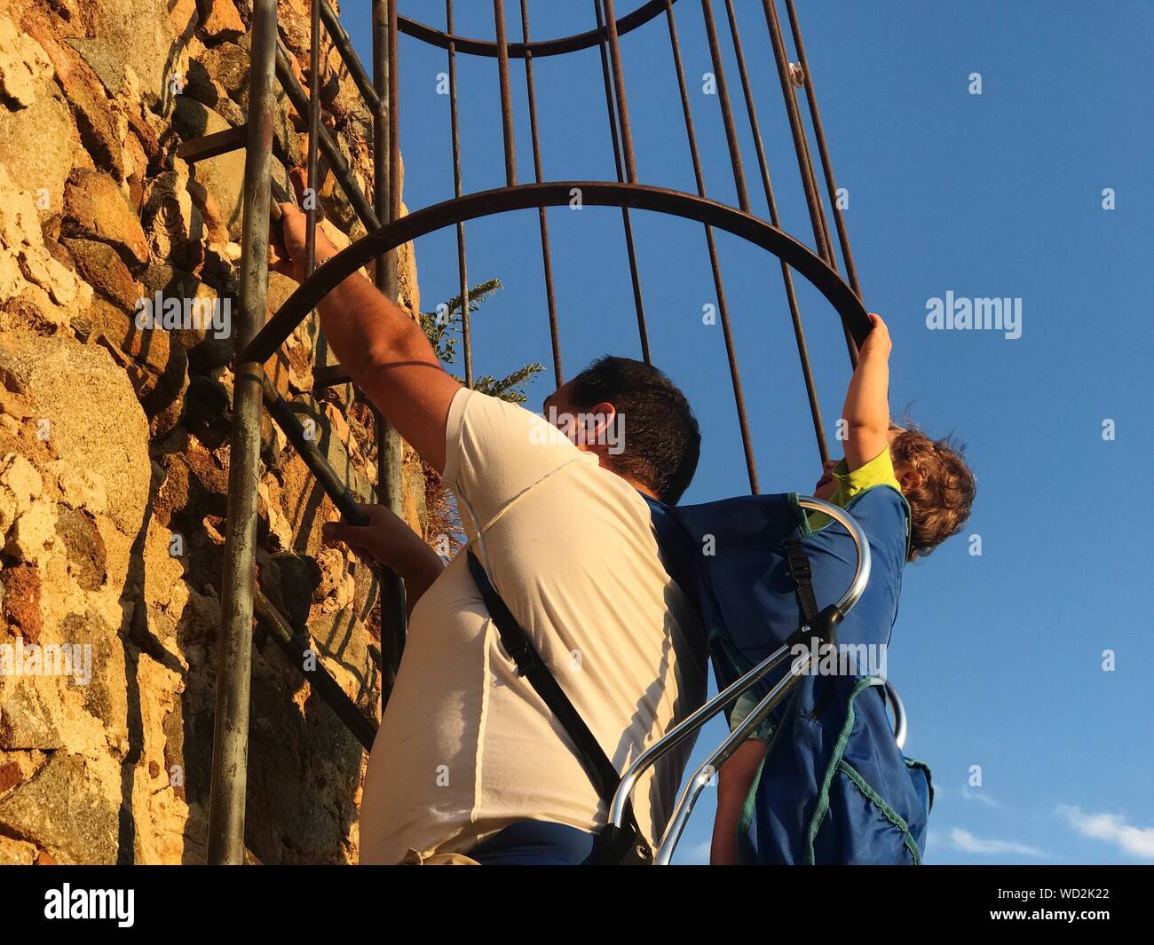 Boy climbing up ladder hi-res stock photography and images - Alamy