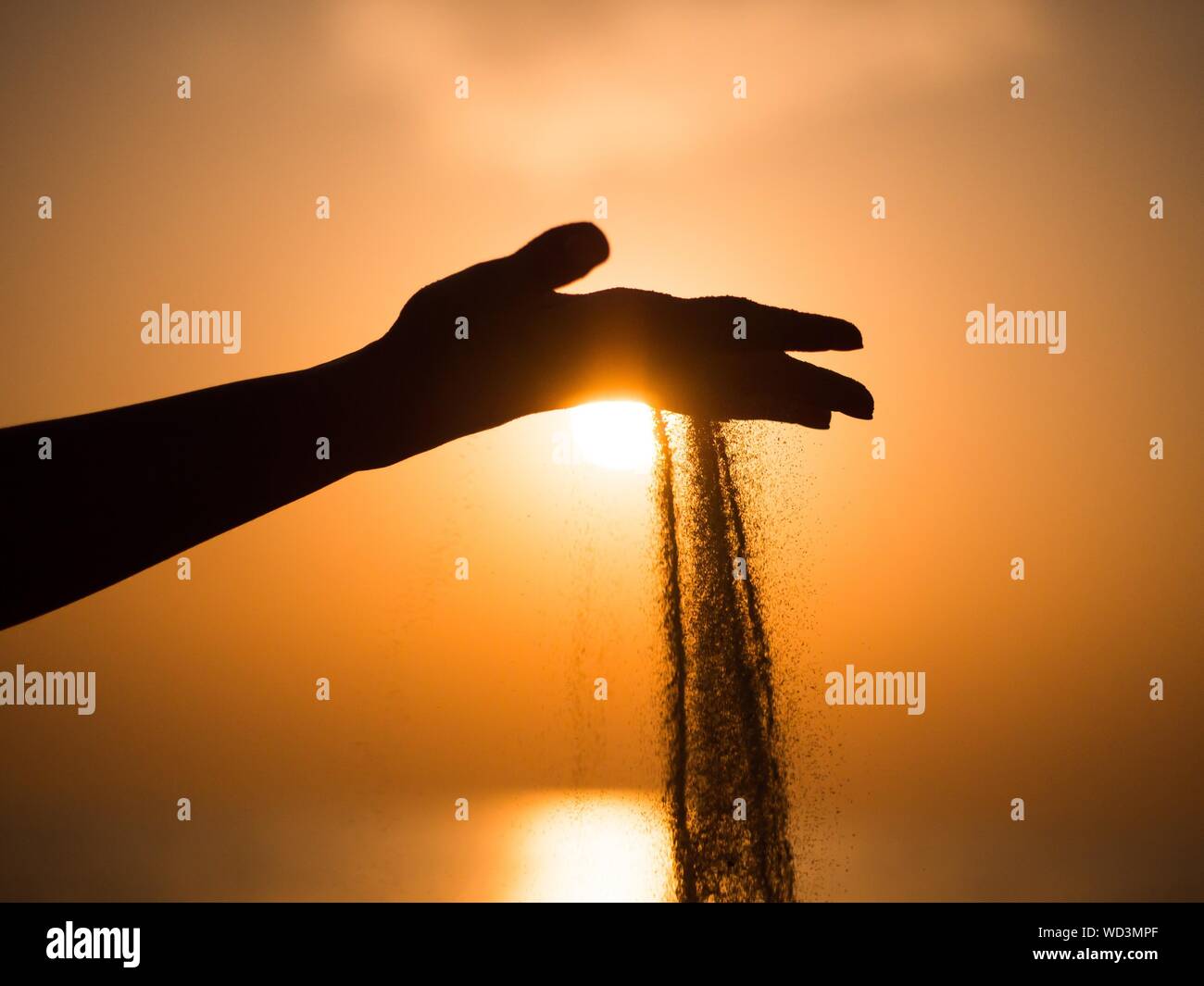 Hand pouring sand hi-res stock photography and images - Alamy