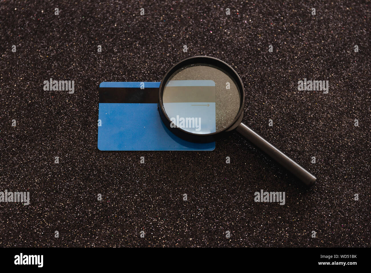 Payment Card And Magnifying Glass Analyzing It On Black Glitter Background Customer Spending