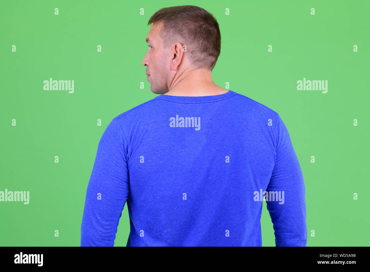 Rear view of macho mature man looking over shoulder Stock Photo - Alamy