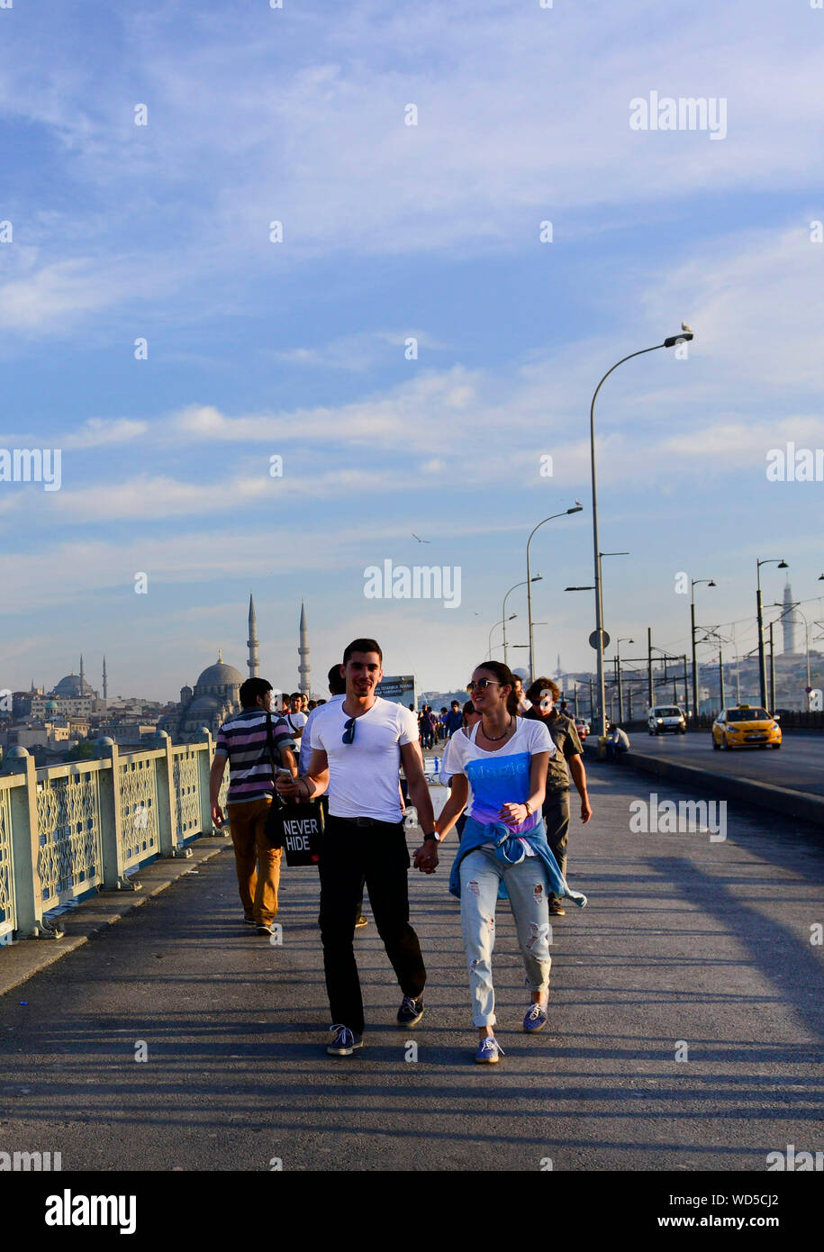 A couple walking on the Galata bridge in Istanbul, Turkey Stock Photo ...