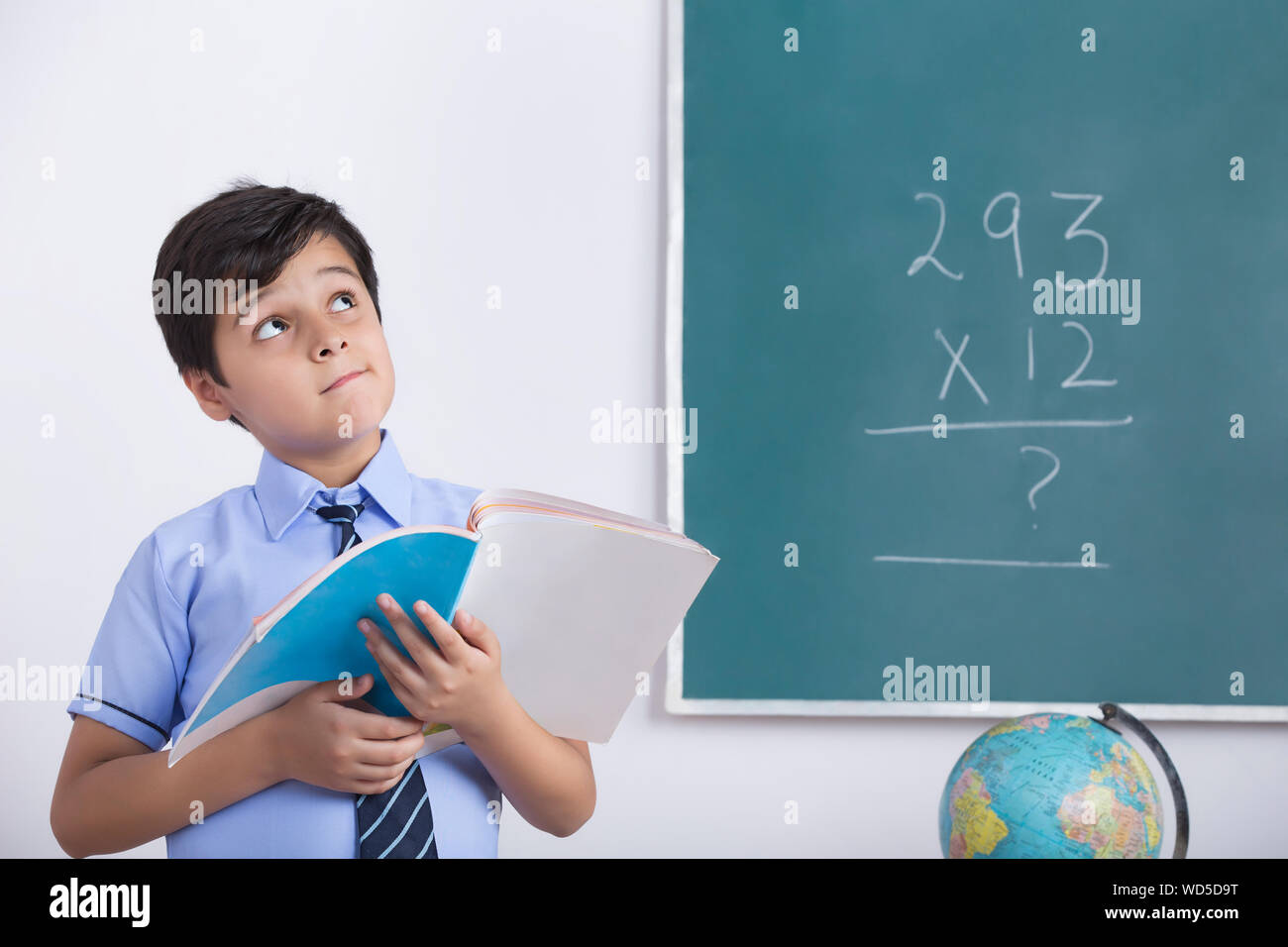 school boy solving maths question on blackboard Stock Photo - Alamy