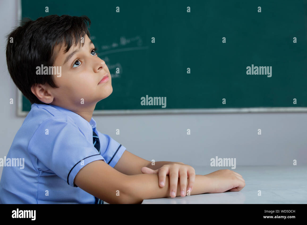 school boy sitting in his class and thinking about something Stock ...