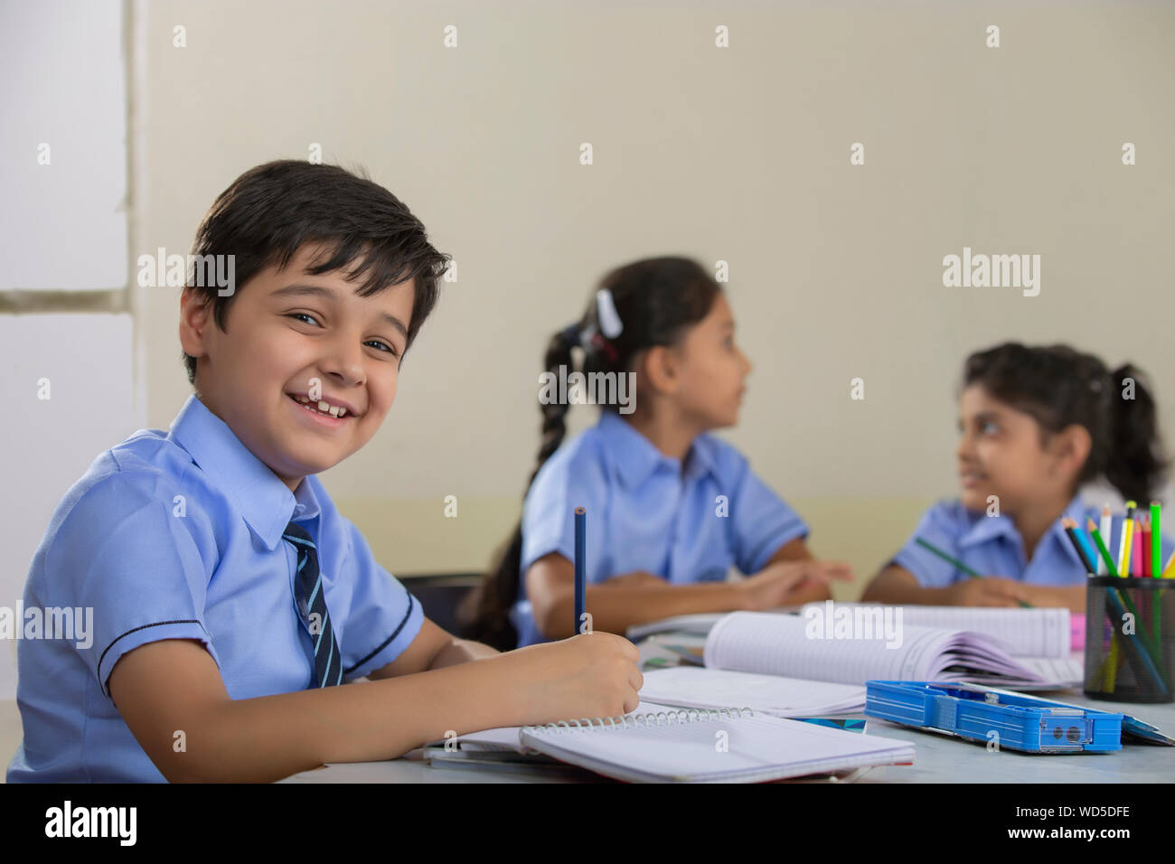 children studying in class and smiling Stock Photo - Alamy