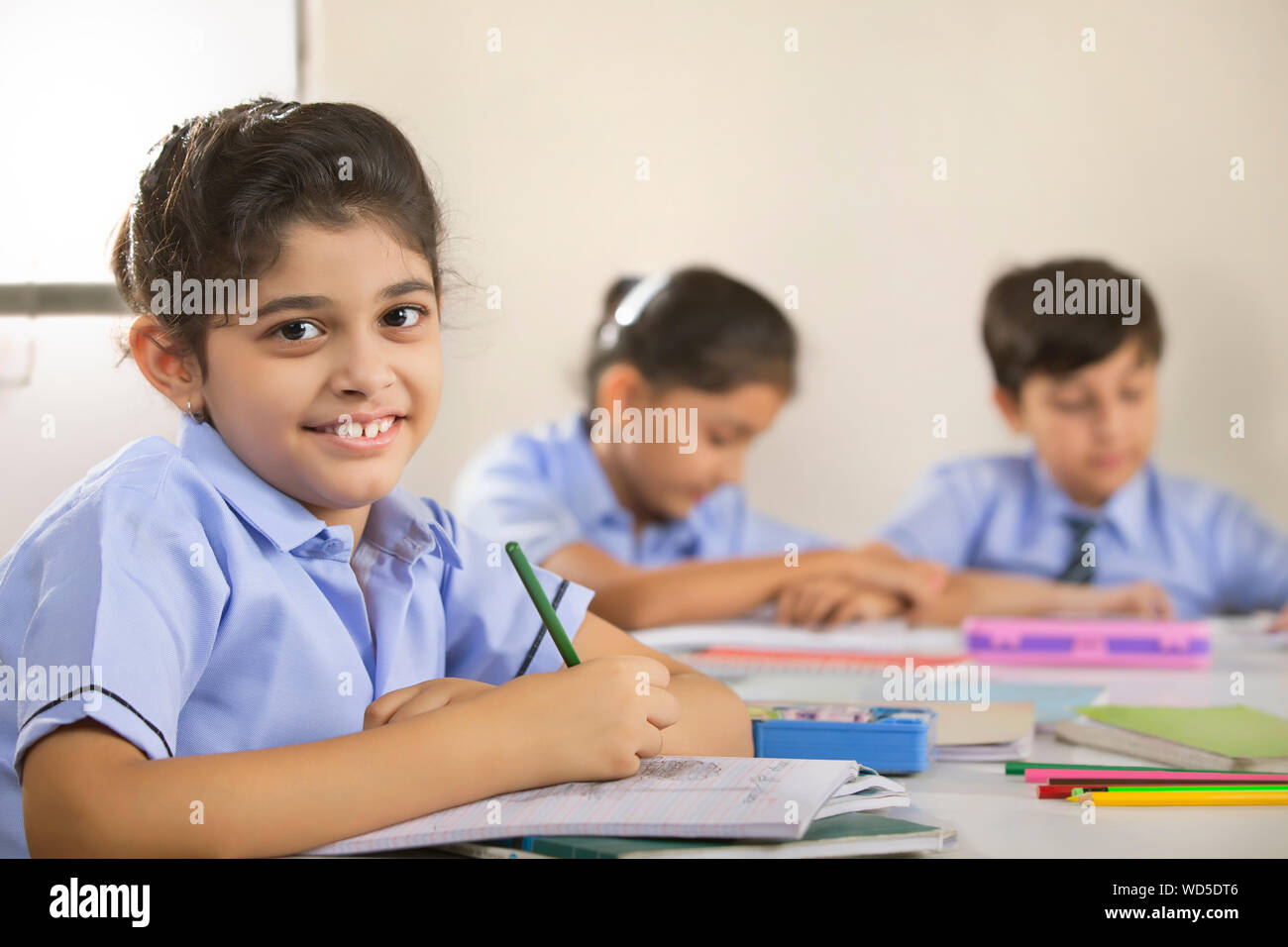 school girl sitting in class and smiling Stock Photo - Alamy