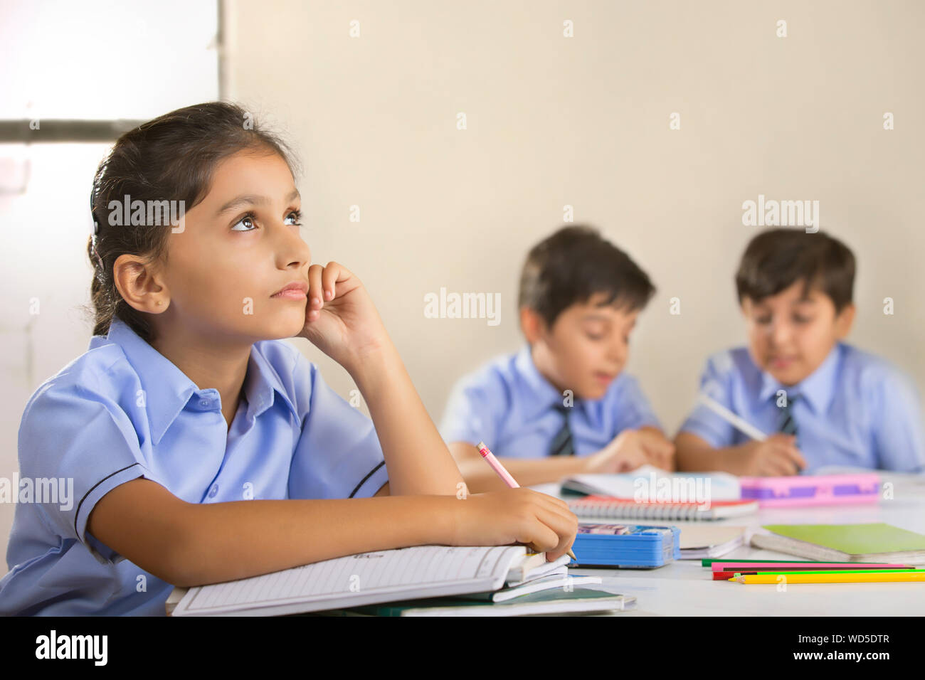 school girl thinking about something while studying in class Stock ...