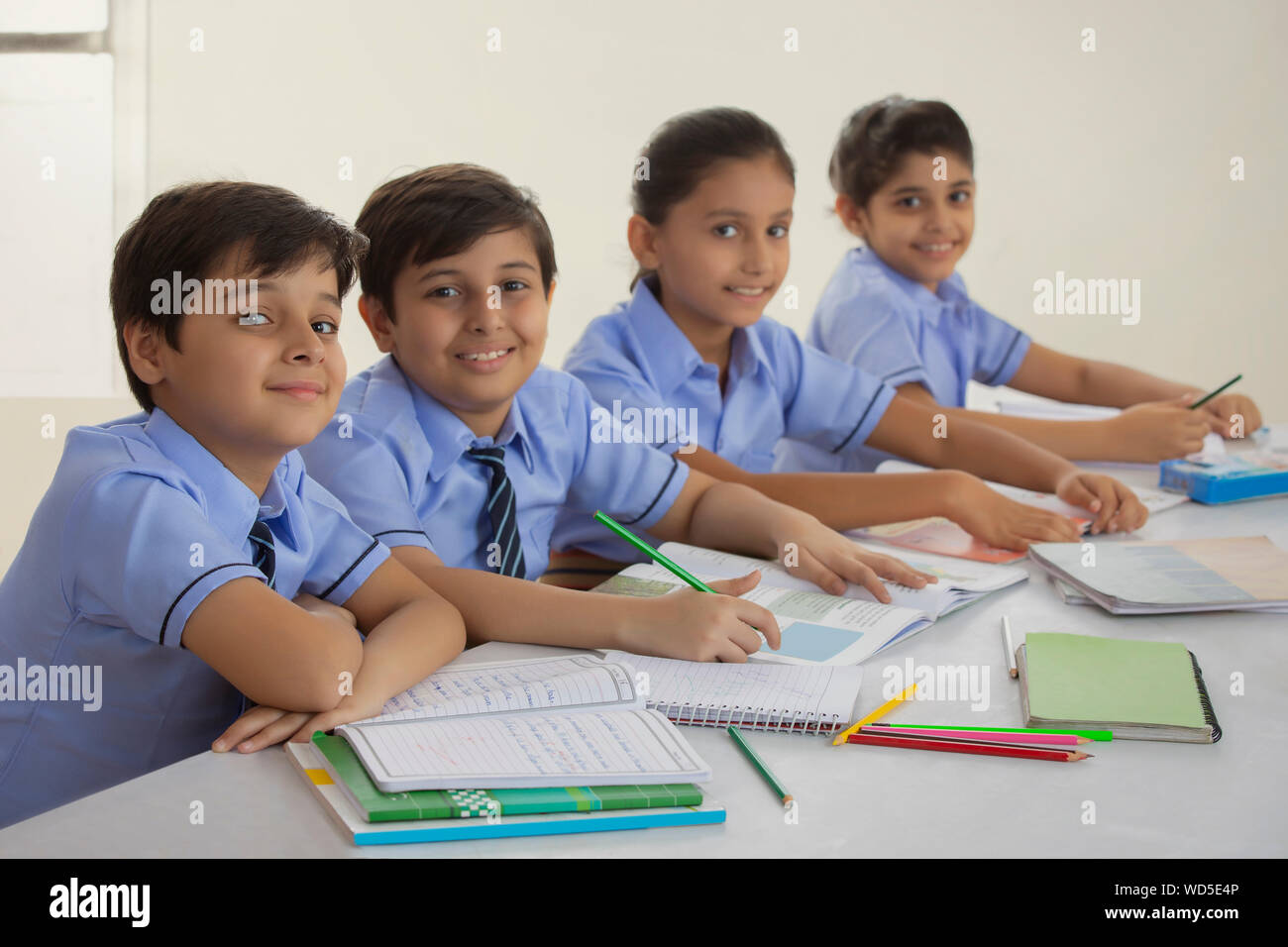 children studying in class and smiling Stock Photo - Alamy