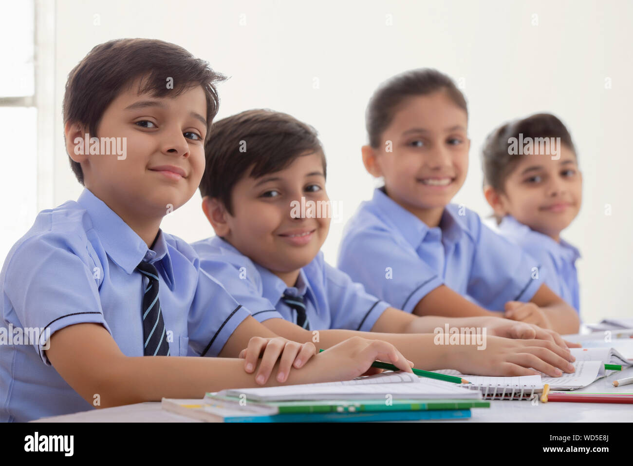 children studying in class and smiling Stock Photo - Alamy