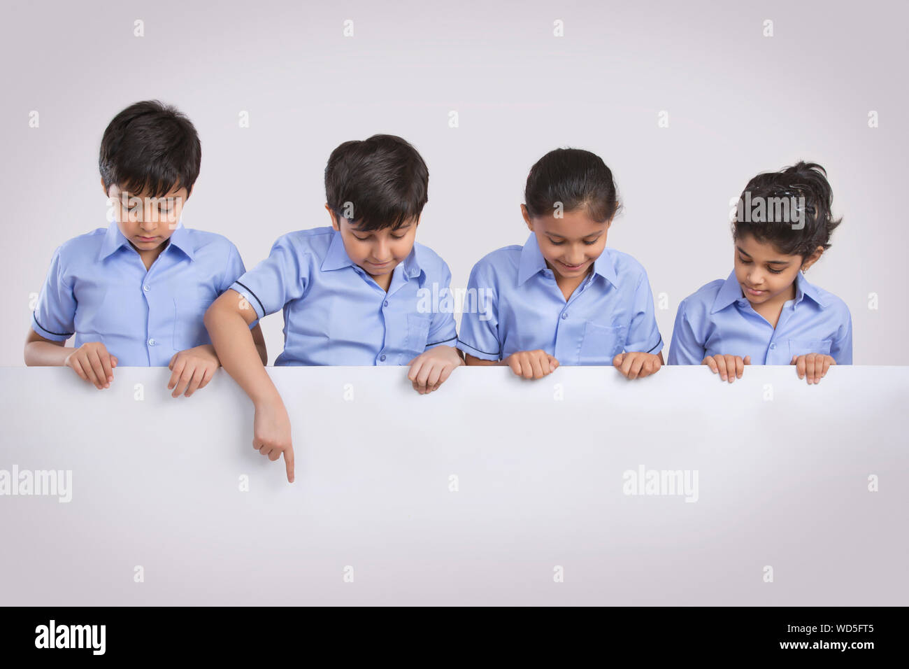 portrait of school children pointing at something Stock Photo - Alamy