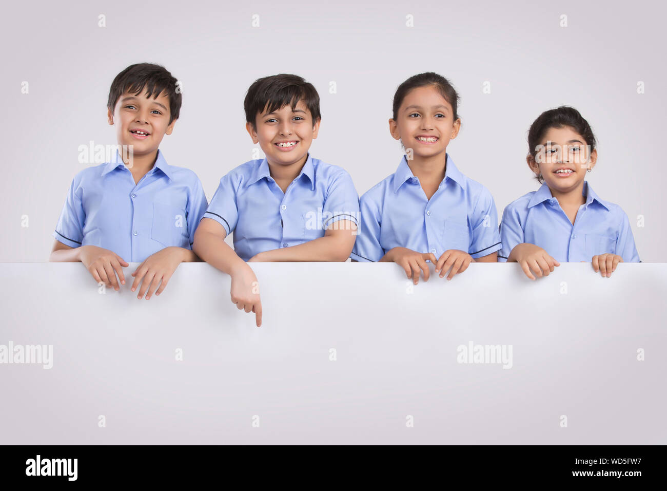 portrait of school children pointing at something Stock Photo - Alamy