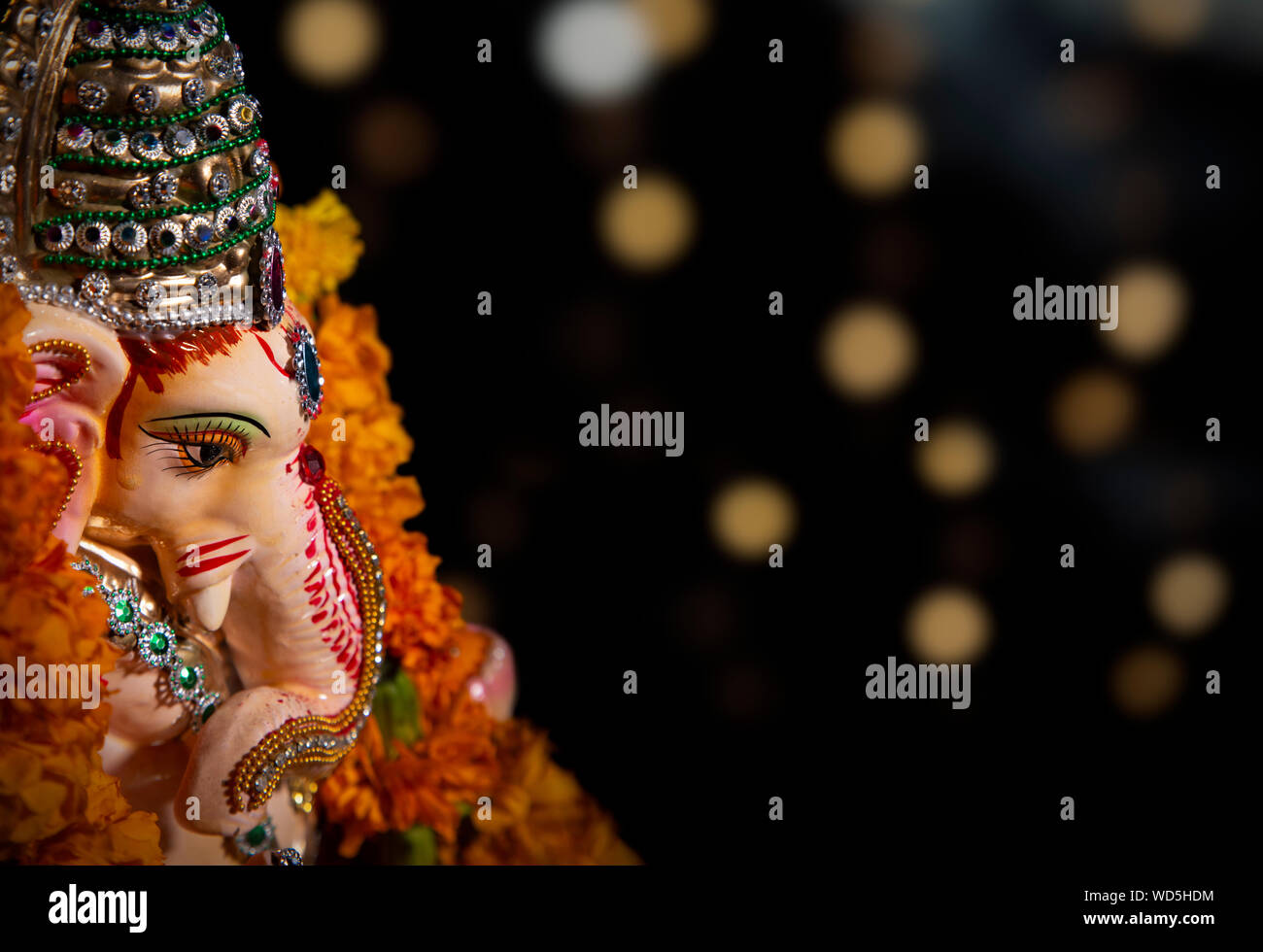top shot of lord ganesha idol with flower garland Stock Photo - Alamy