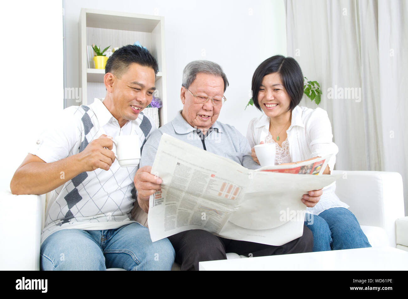 Family Reading Newspaper High Resolution Stock Photography and Images ...