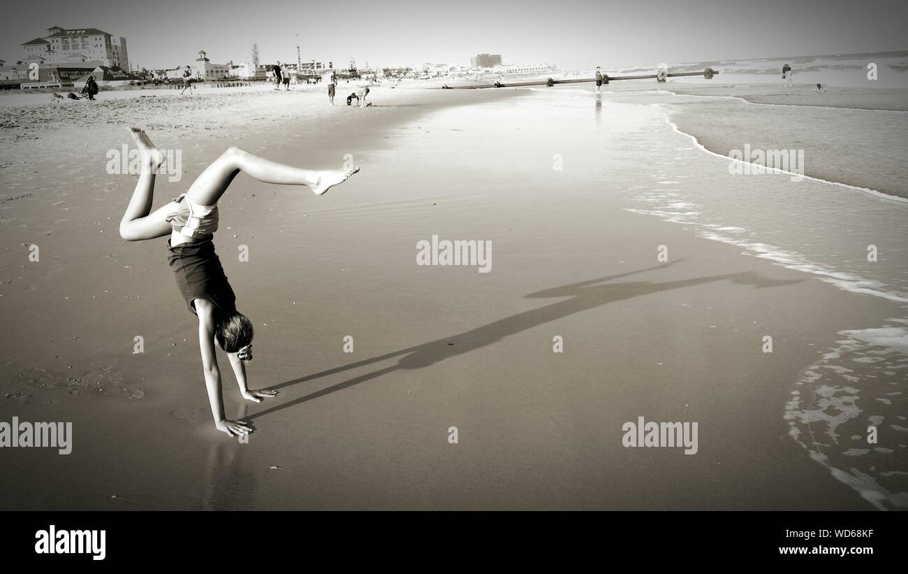 Woman doing handstand on beach hi-res stock photography and images - Alamy