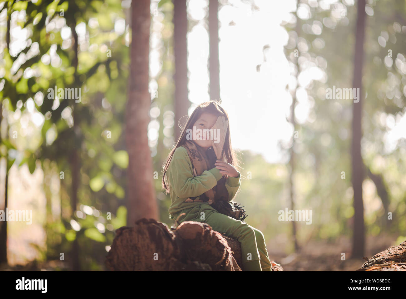 Girl sitting on tree forest hi-res stock photography and images - Alamy