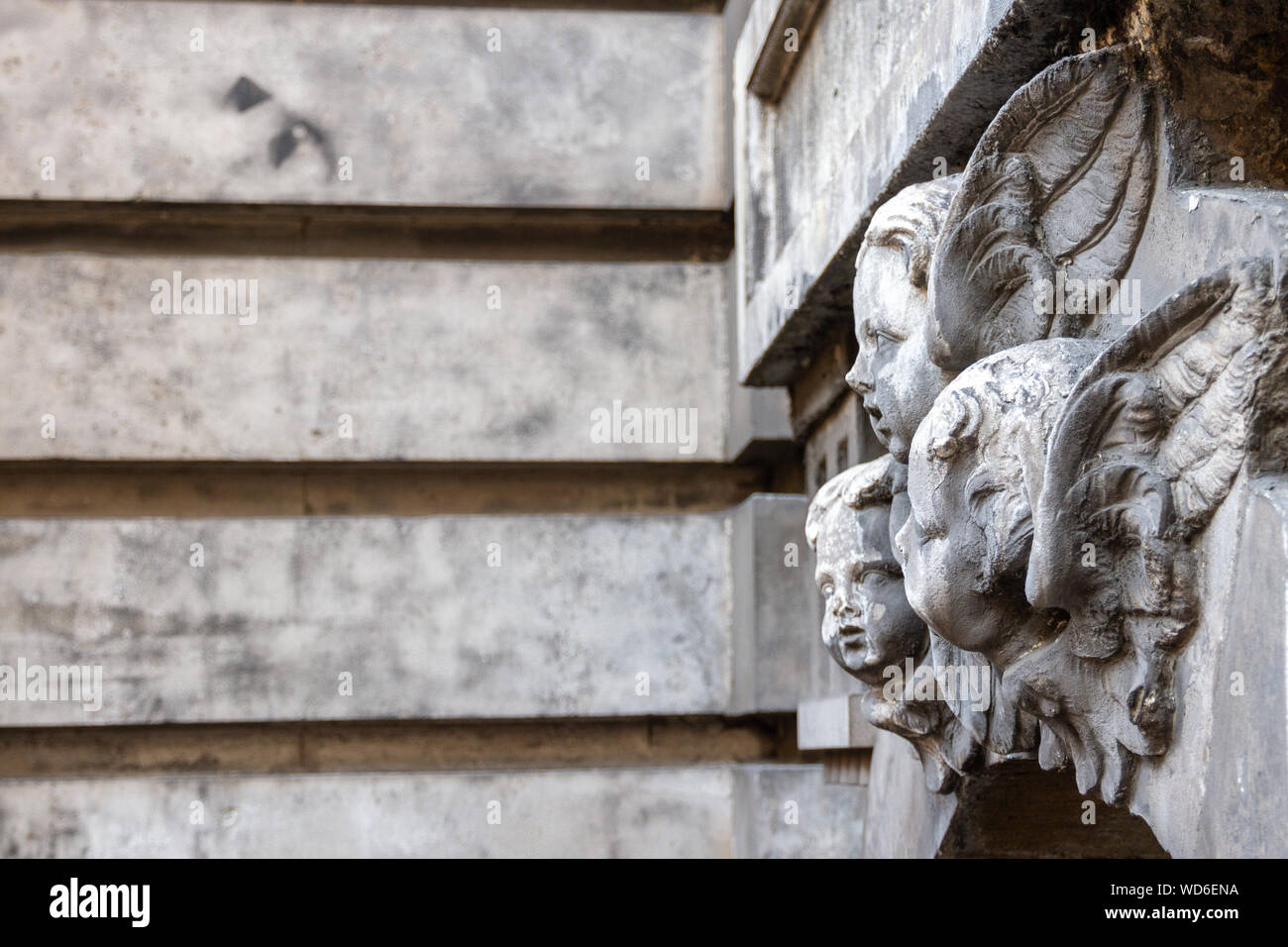 A monochrome photograph of the heads of three cherubs on the wall of St ...