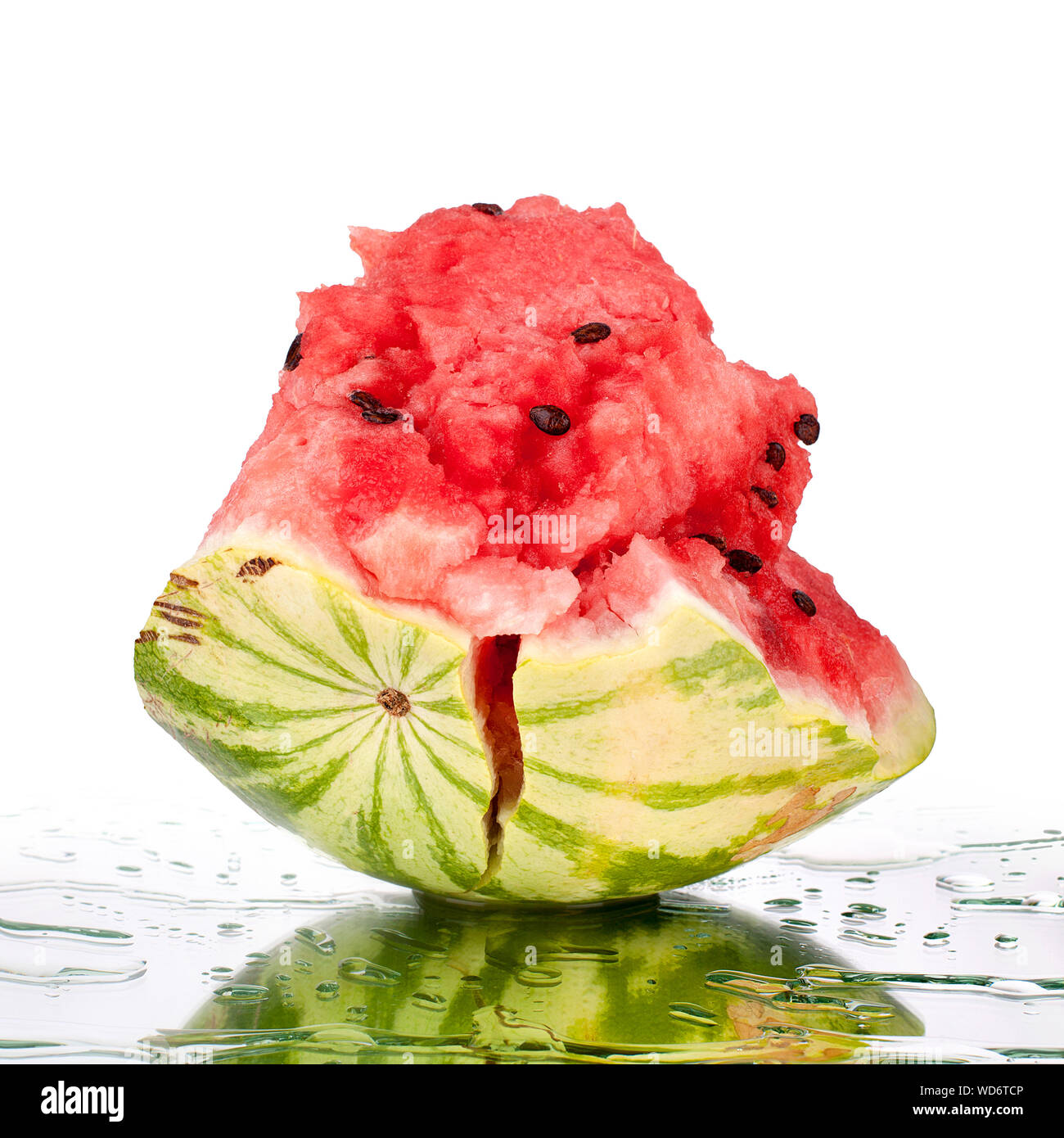Cracked watermelon on white mirror background in water drops isolated ...