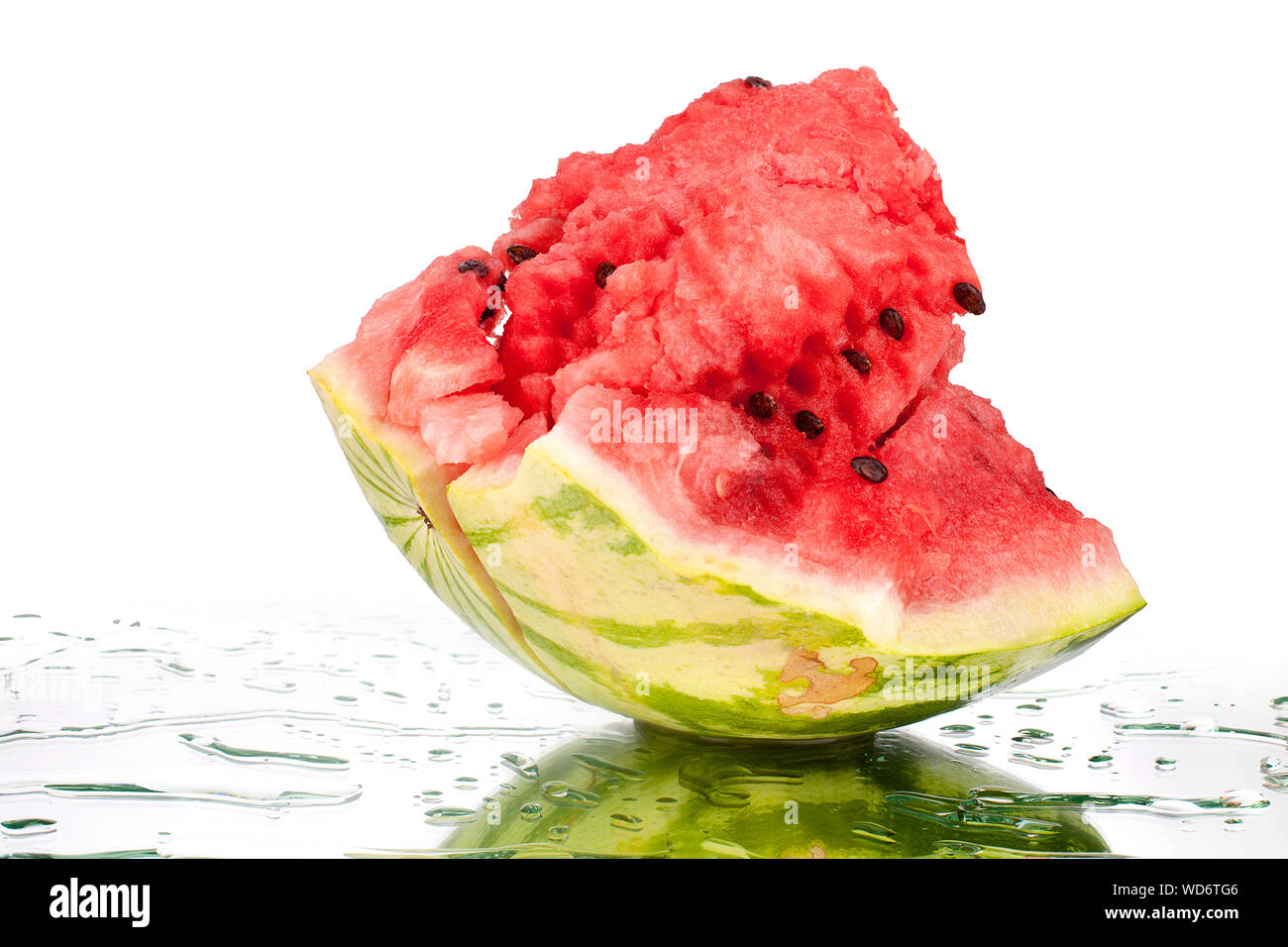 Cracked watermelon on white mirror background in water drops isolated ...