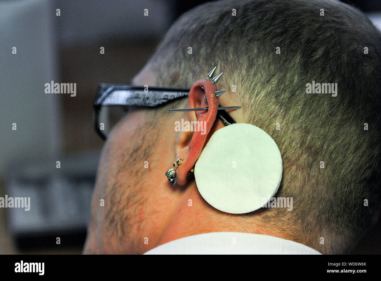 Man ear piercing hi-res stock photography and images - Alamy