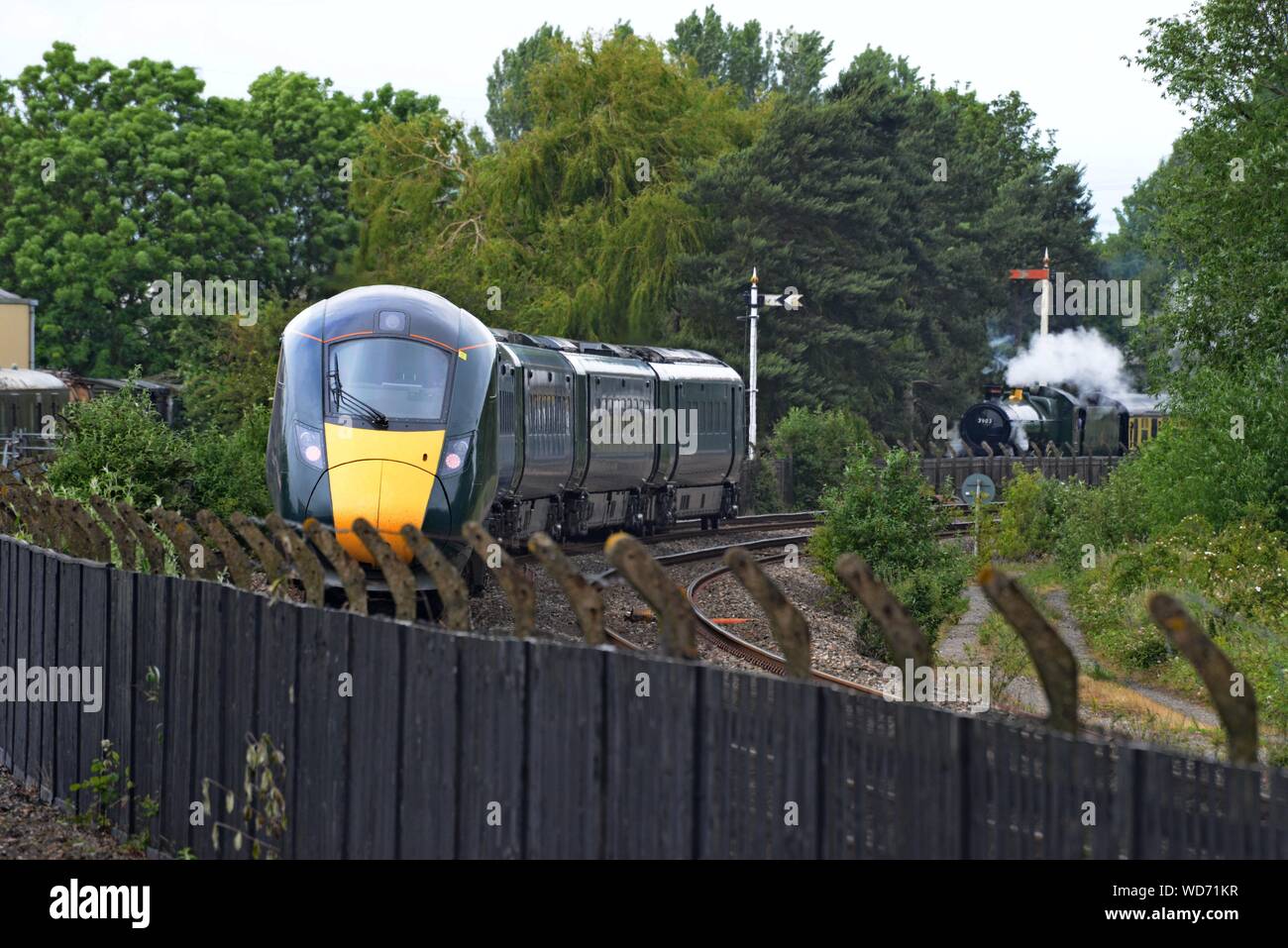 Steam locomotive 7903 'Foremark Hall' passes alongside a GWR 800 class ...