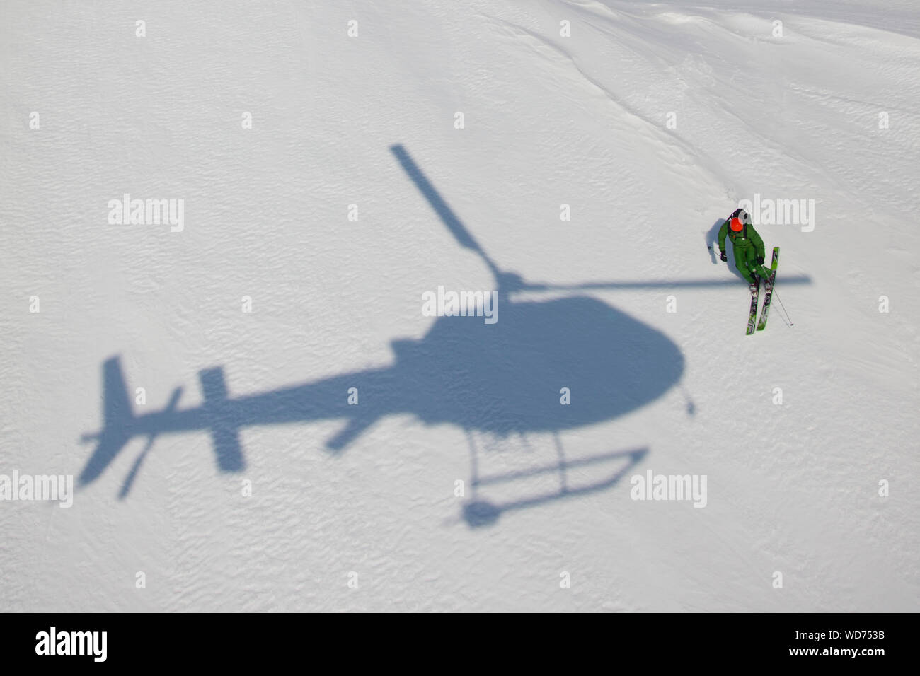 Elevated view of skier and helicopter's shadow in Lapland, Sweden Stock ...