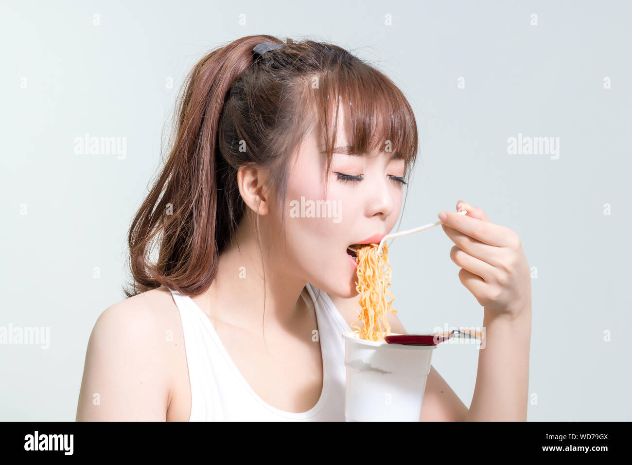 Asian person eating noodles hi-res stock photography and images - Alamy