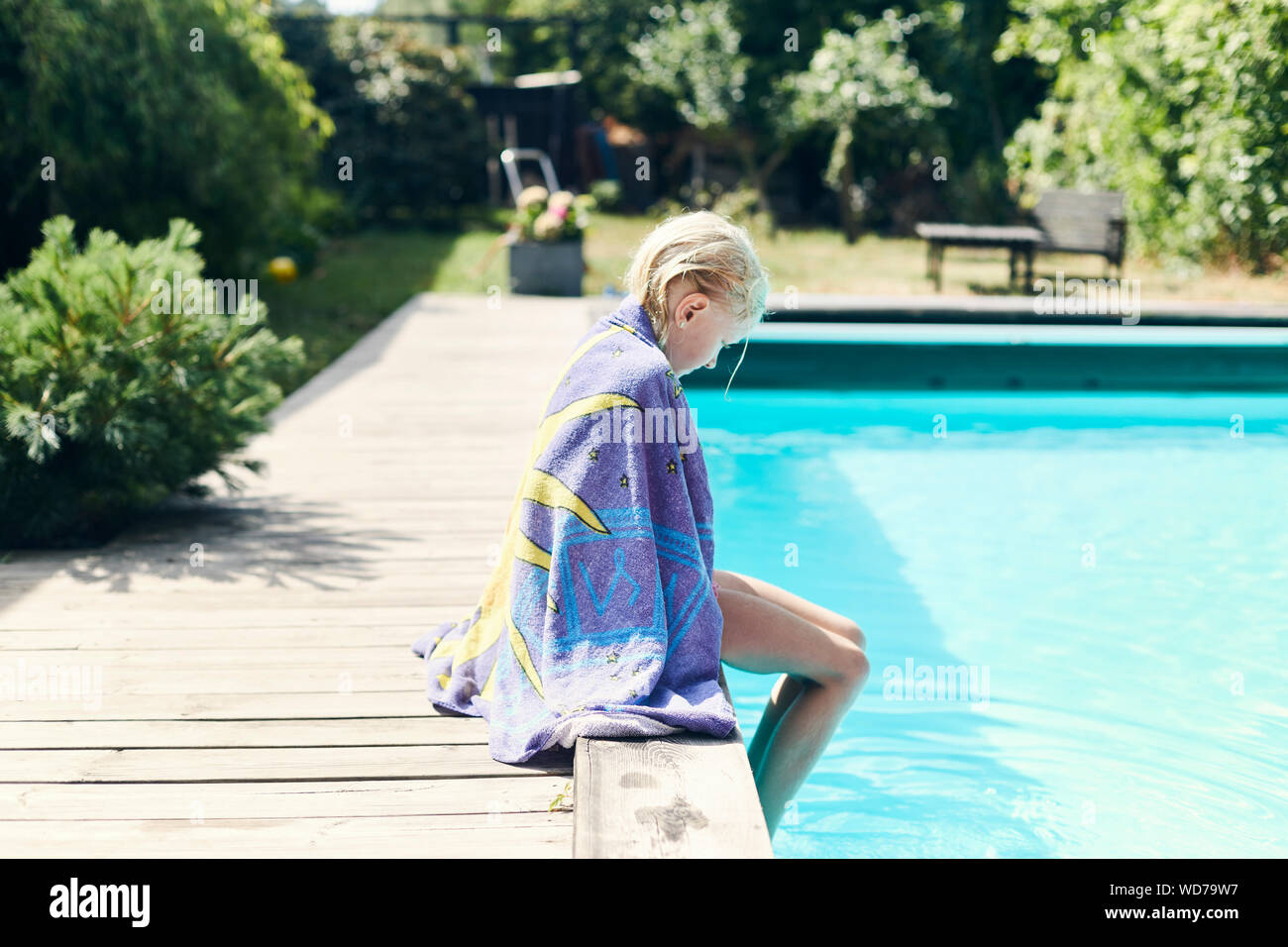 Girl sitting poolside Stock Photo - Alamy