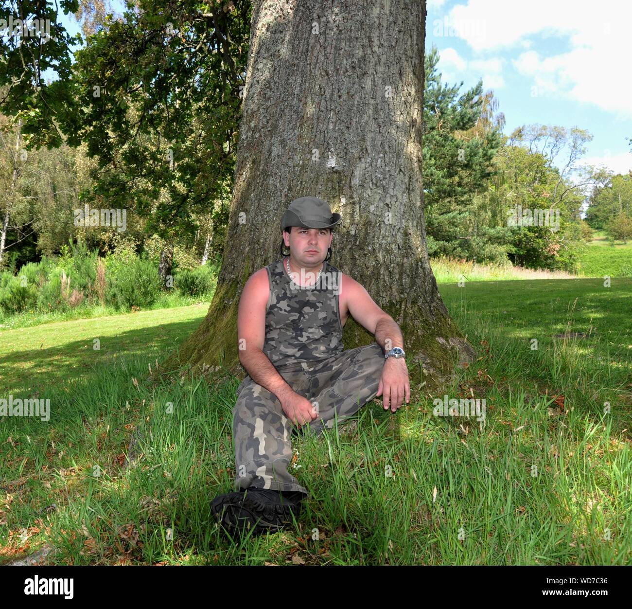 Man Sitting Against Tree Trunk High Resolution Stock Photography and ...