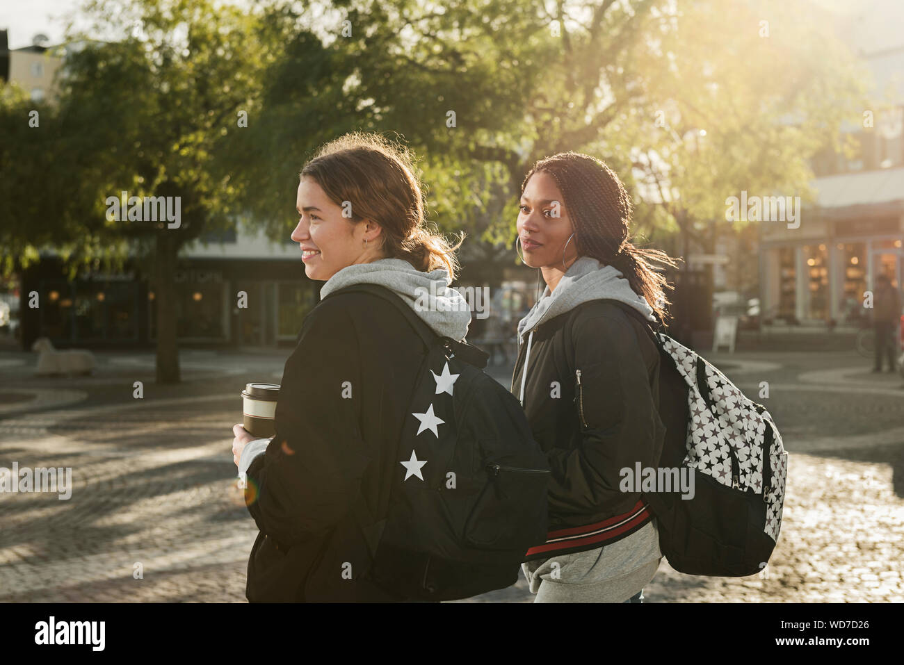 Teenage girls wearing backpacks Stock Photo - Alamy