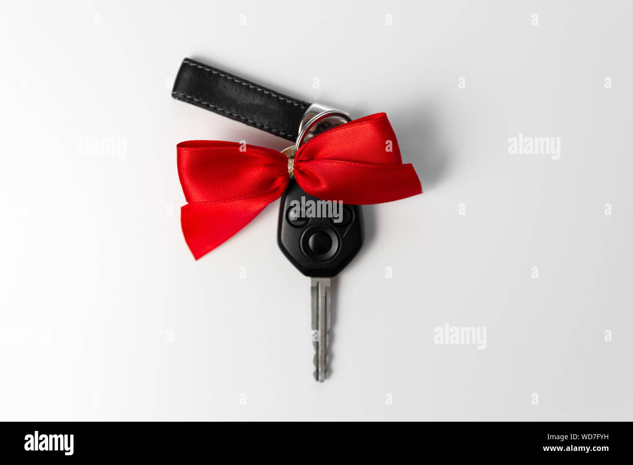 Car keys with red bow as present on white background. New car gift ...