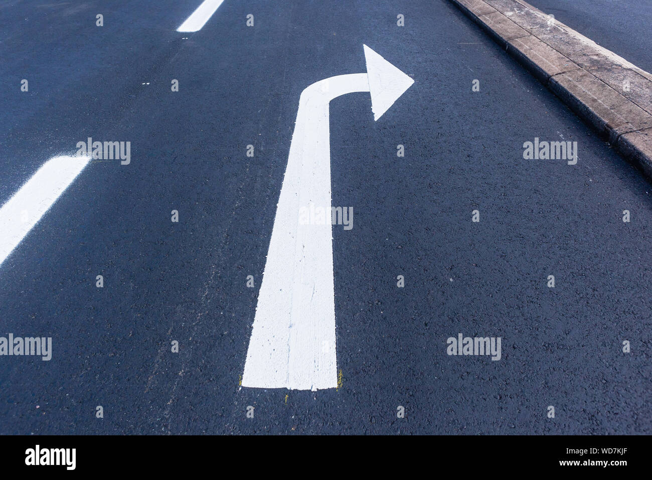 Road highway asphalt tarmac painted direction marking of white arrow ...