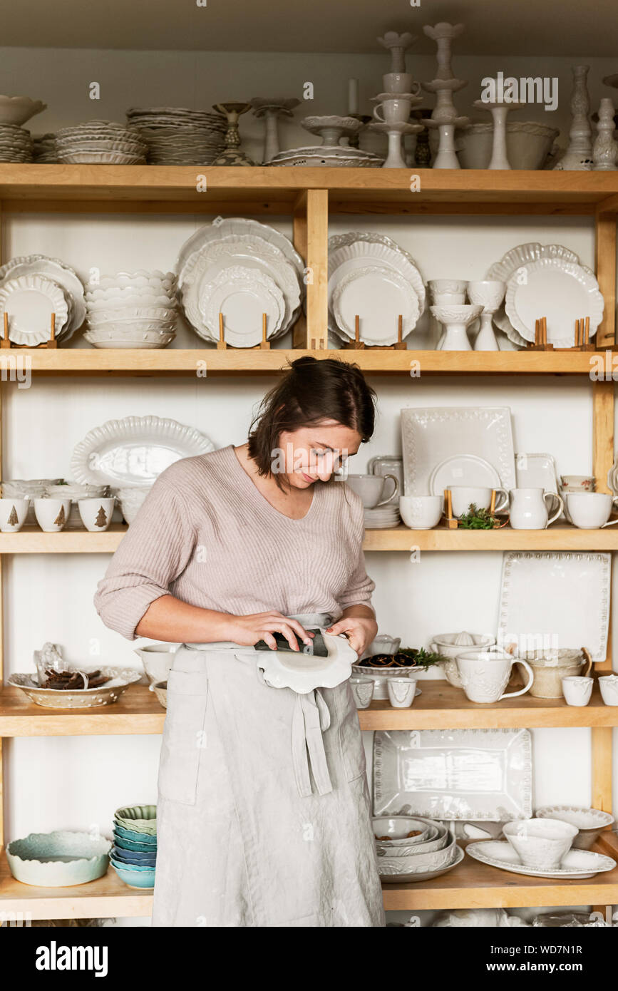 Young woman pottery apron hi-res stock photography and images - Alamy