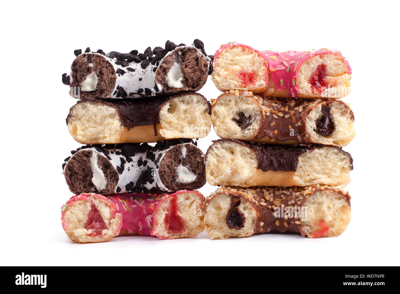 Broken donuts with different fillings on white background close up ...