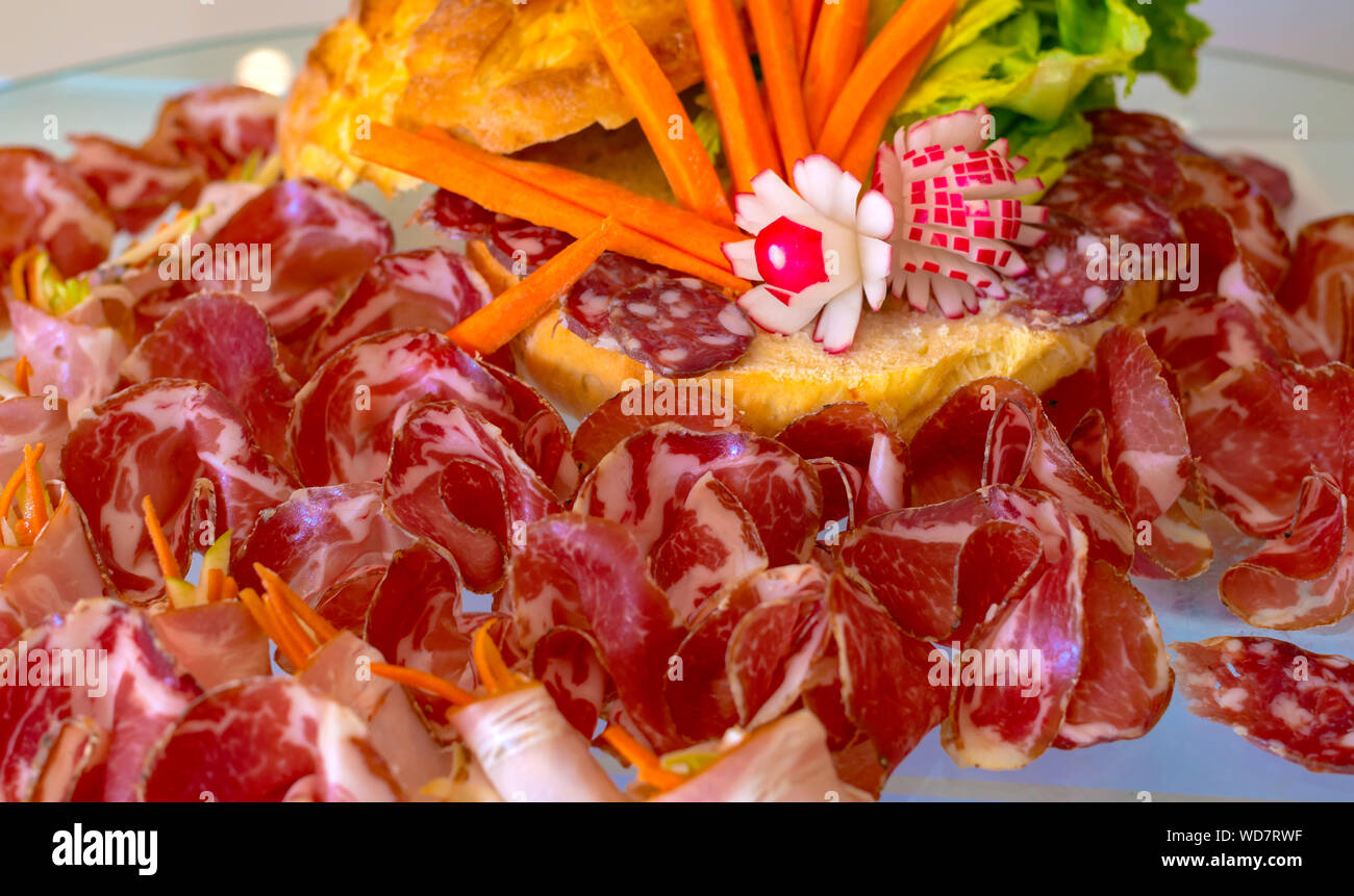 Parma ham sliced and placed on a tray with garnish of fresh vegetables ...
