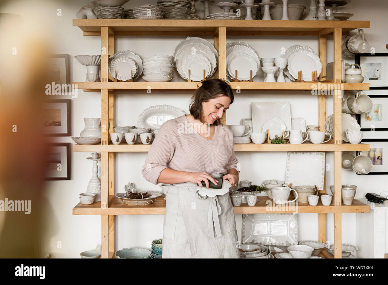 Young woman pottery apron hi-res stock photography and images - Alamy
