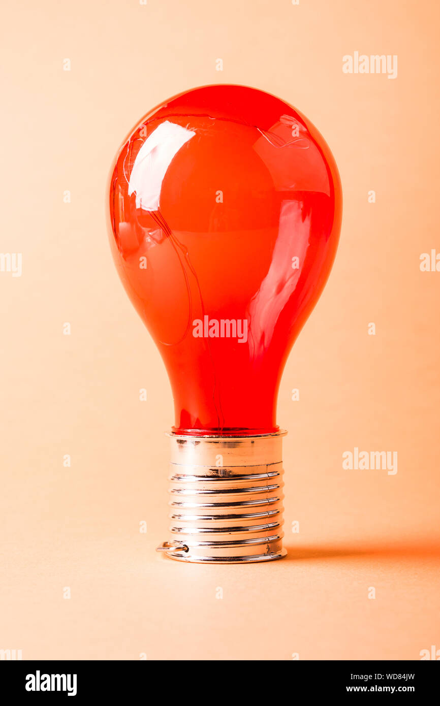 Red solar power light bulb on abstract orange background. Ecofriendly ...
