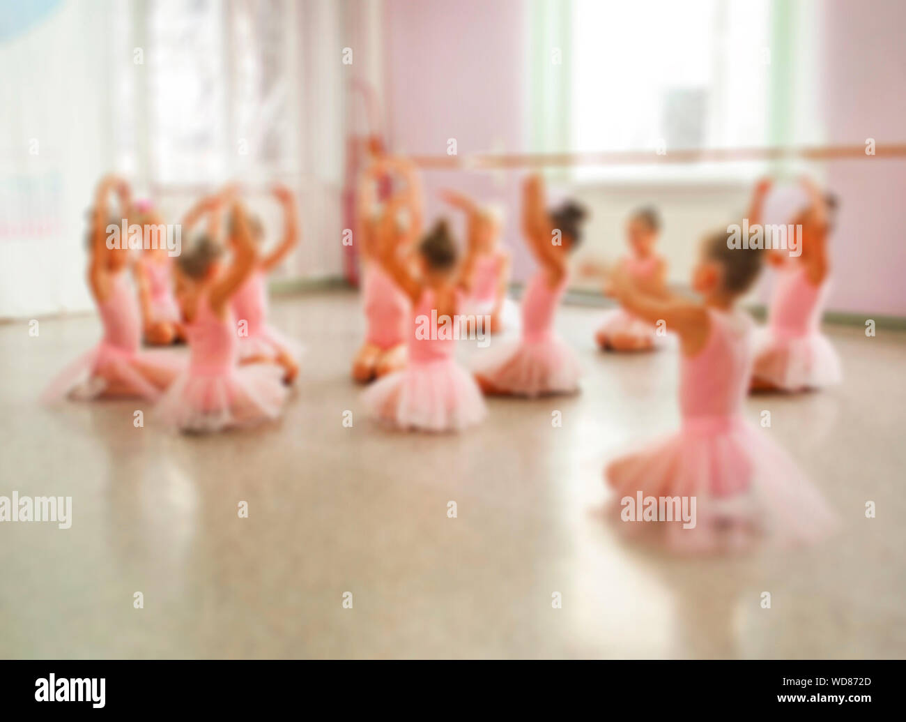 Blurred picture of group of litle ballerinas in pink dresses on a ...