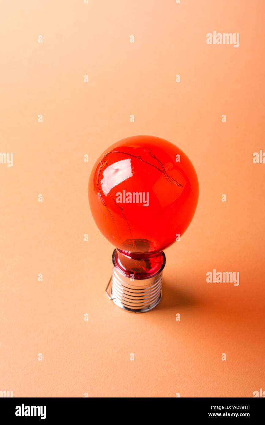 Red solar power light bulb on abstract orange background. Ecofriendly ...