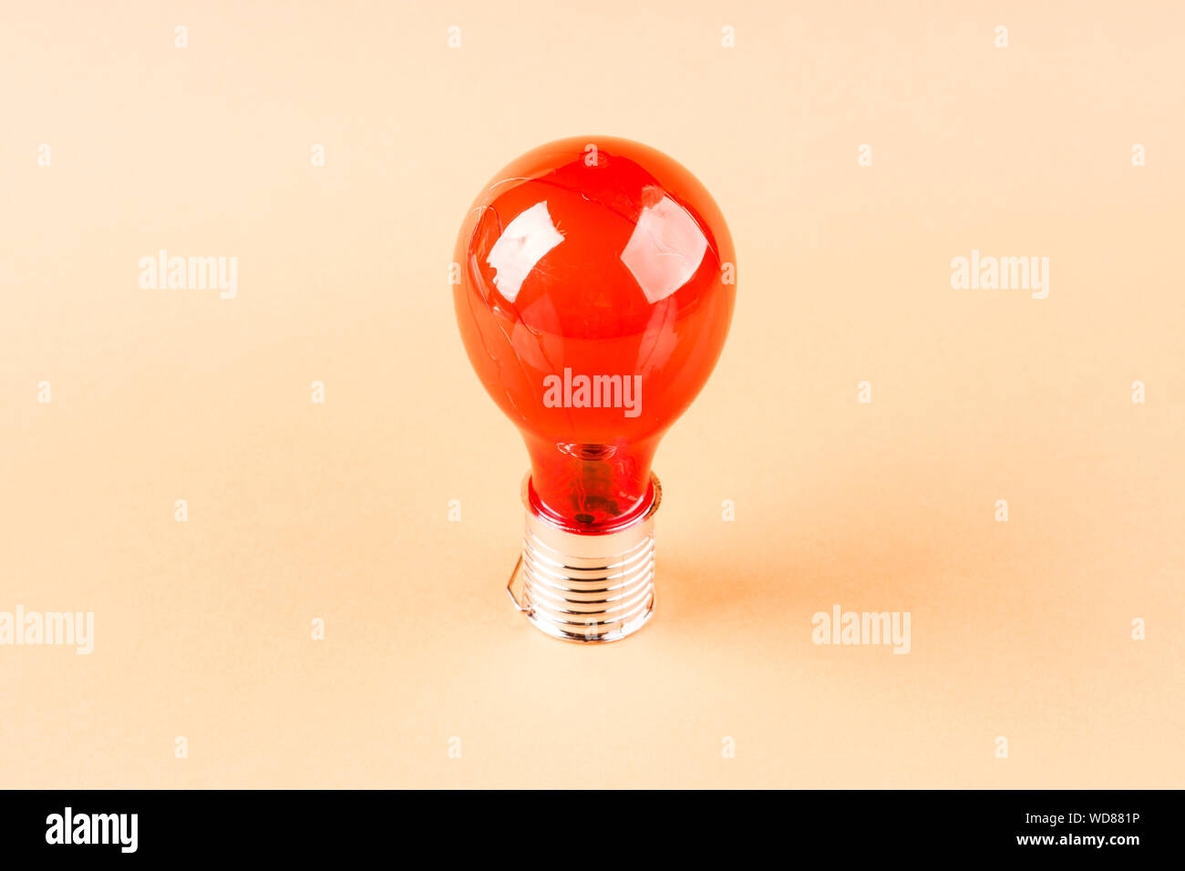 Red solar power light bulb on abstract orange background. Ecofriendly ...