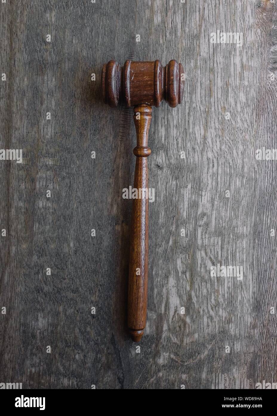 Vertical shot of a brown mallet on a gray wooden surface Law and ...