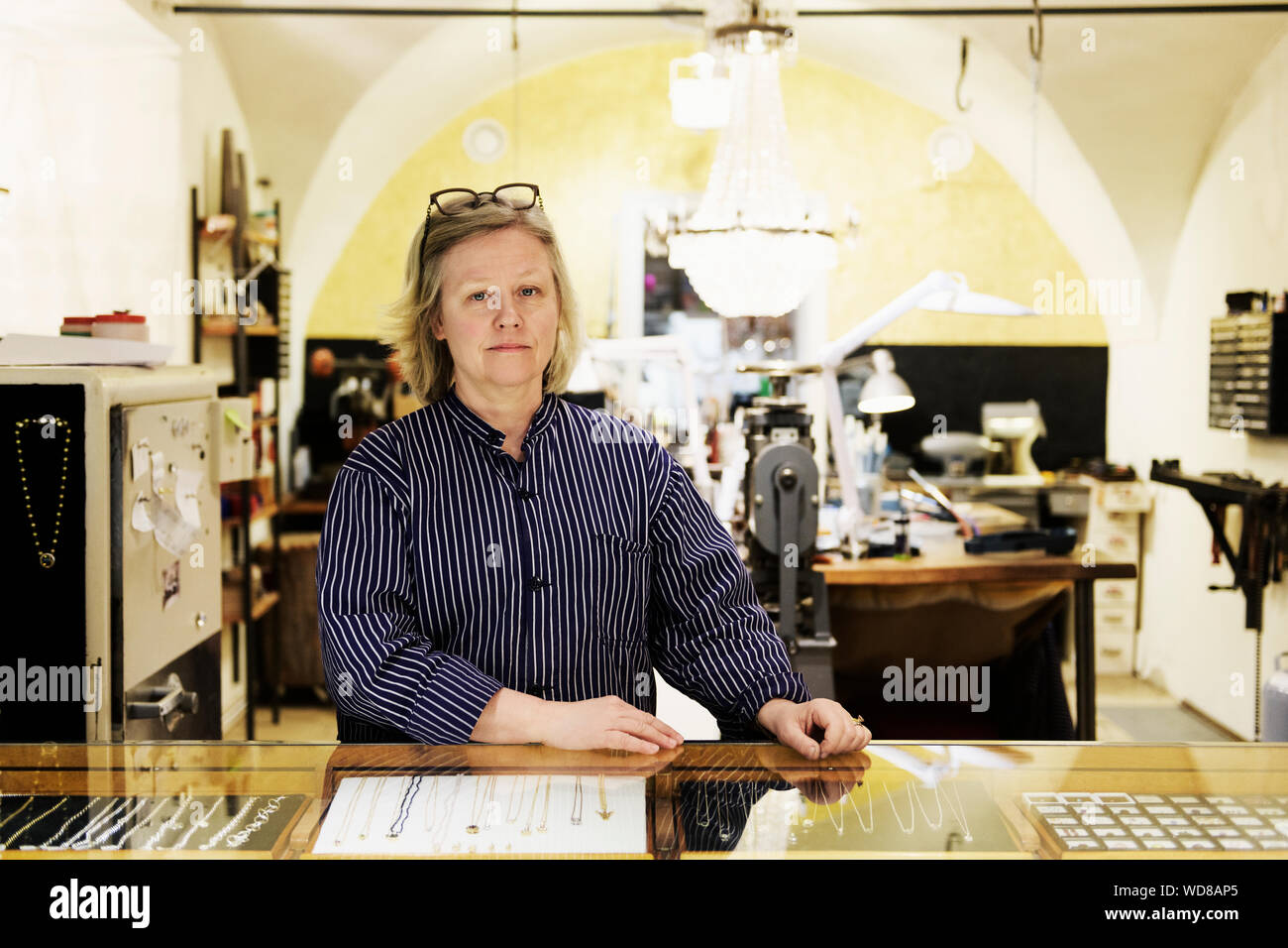 Portrait of goldsmith at counter of her jewellery store Stock Photo - Alamy