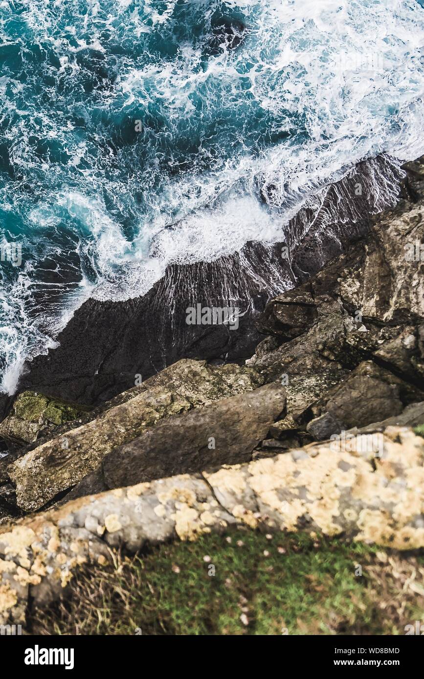 Vertical high angle shot from the top of the cliff near the sea with ...