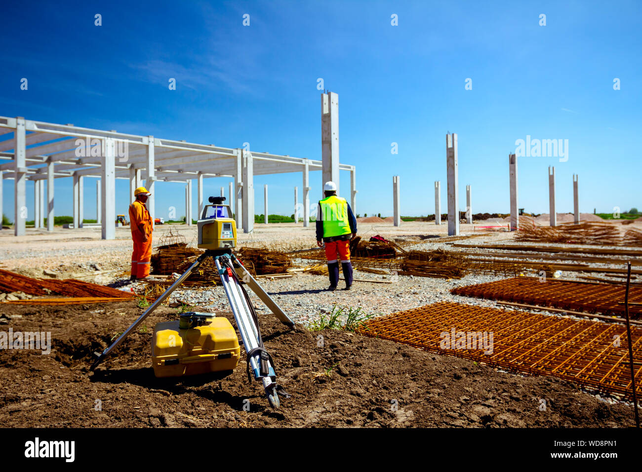 View from behind on construction worker, foreman with safety vest and ...
