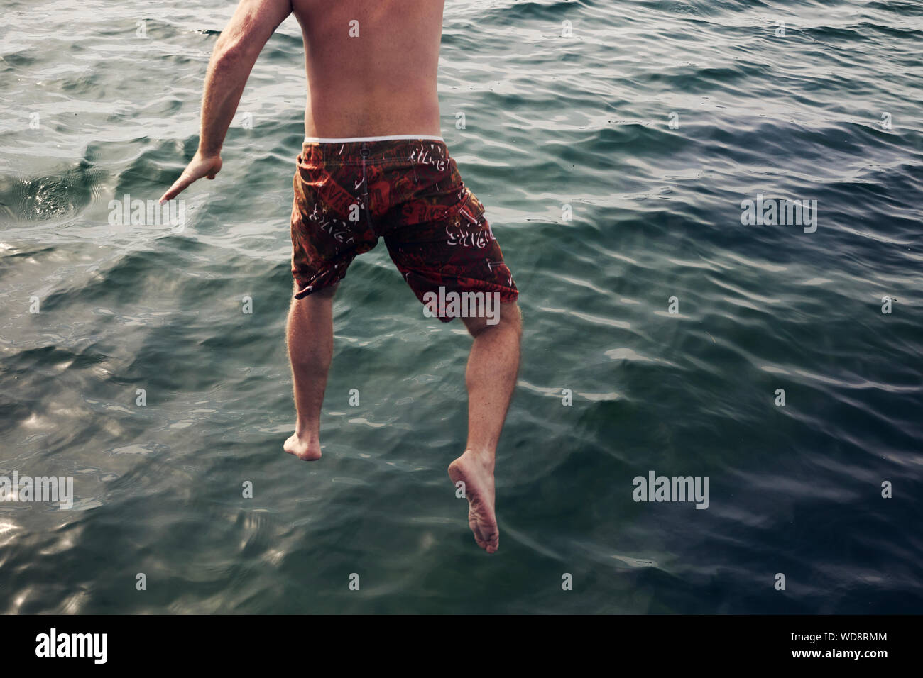 Man jumping water hi-res stock photography and images - Alamy