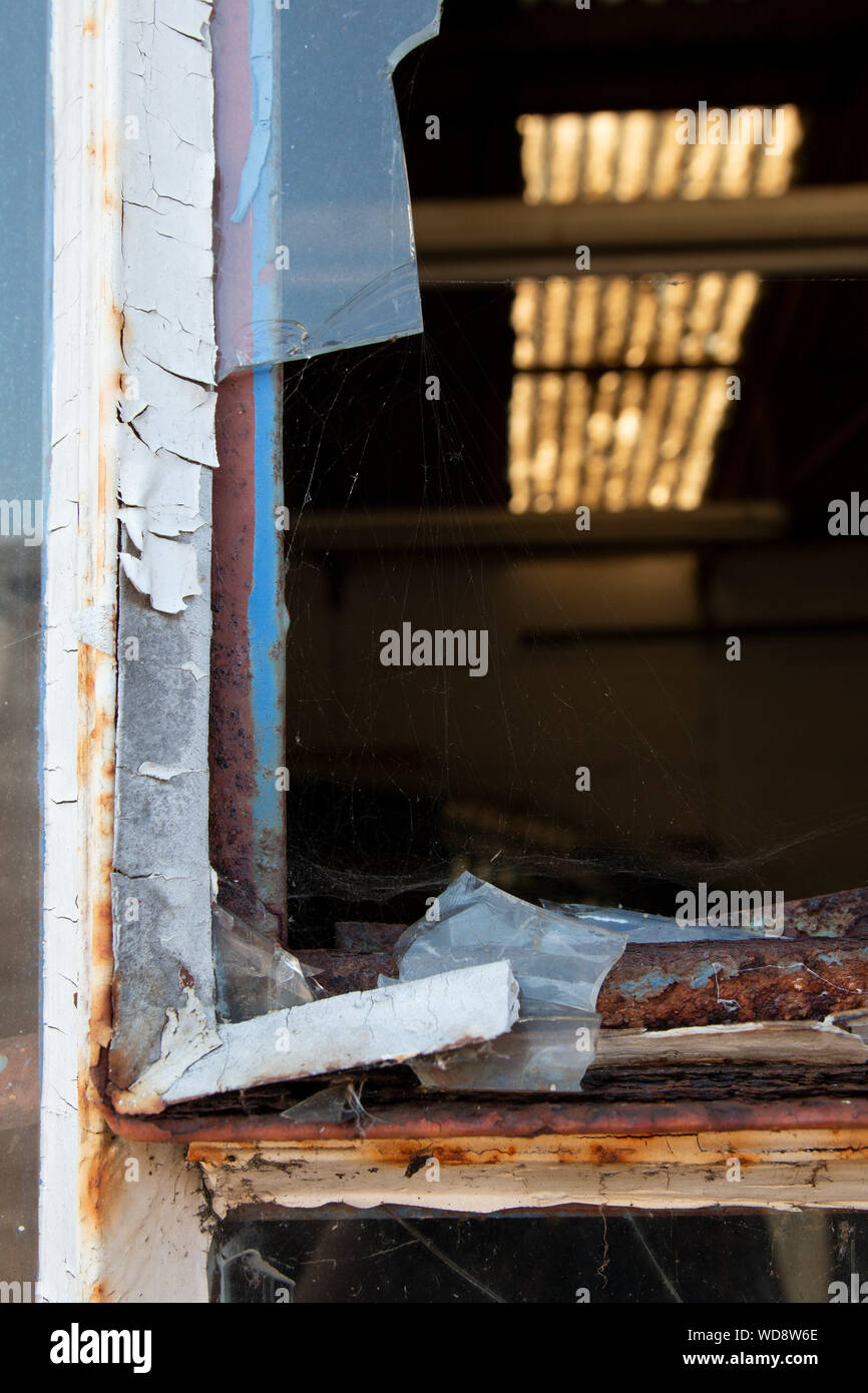 Window frame on a garage showing broken window panes Stock Photo - Alamy