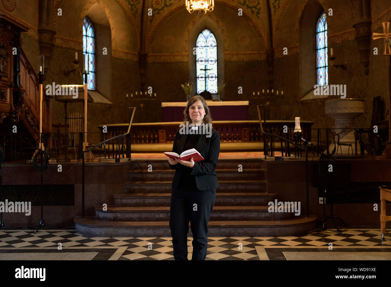 Priest holding bible hi-res stock photography and images - Alamy