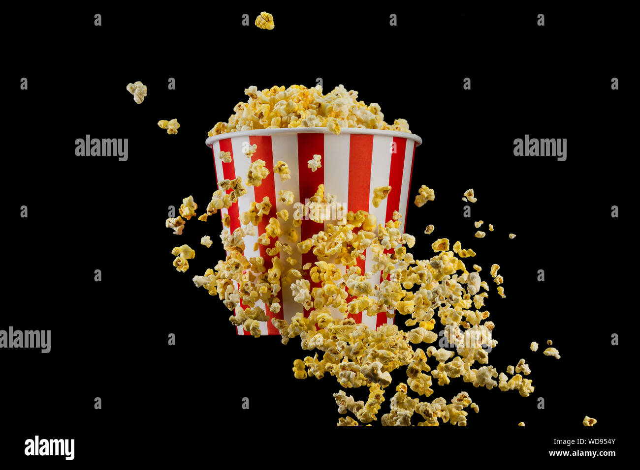 Flying popcorn from striped bucket isolated on black background Stock ...