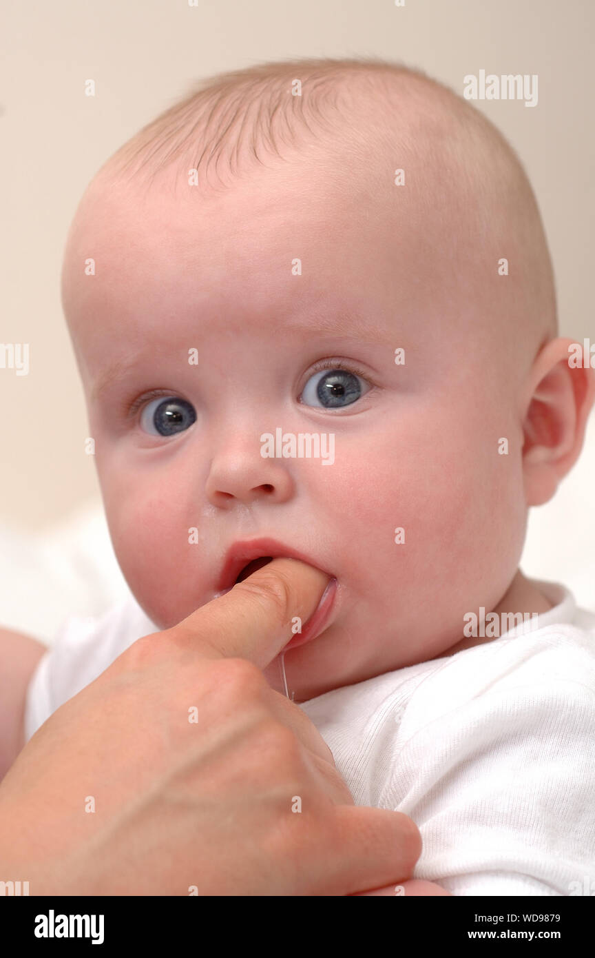 Mum giving teething medication to her six month old son Stock Photo - Alamy