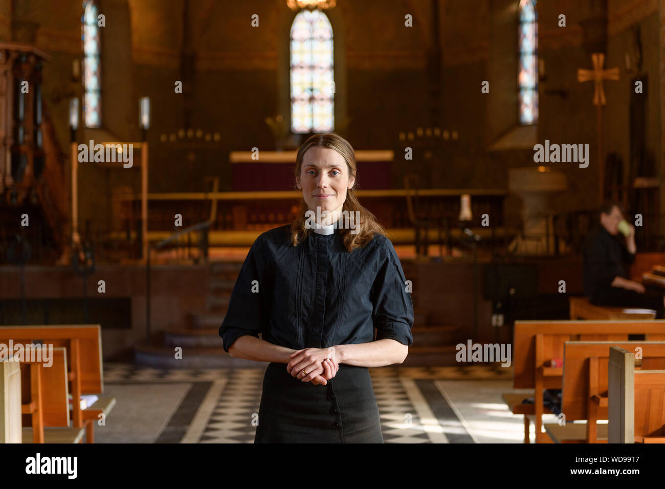 Portrait of priest in church Stock Photo - Alamy